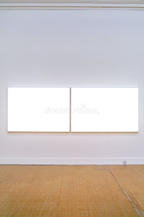 Vertical Shot of 2 Empty White Frames on a White Wall Inside of a Art ...