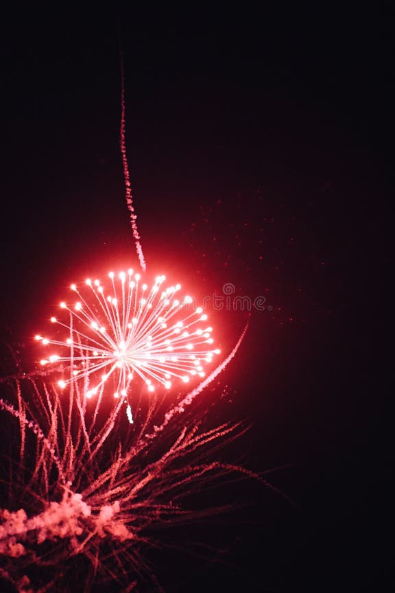 Vertical Shot of Exploding Red Fireworks in a Night Sky Stock Image ...
