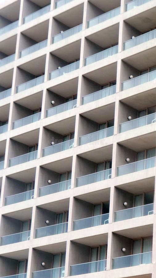 Vertical Shot of the Facade of a Tall Building with Many Balconies ...