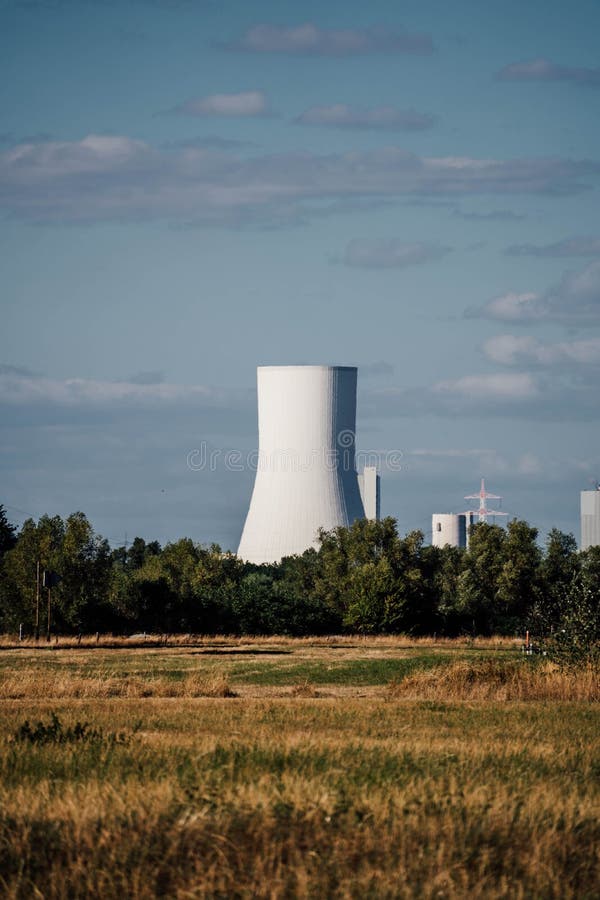 Vertical Shot of a Factory and a Field in the Foreground Stock Photo ...