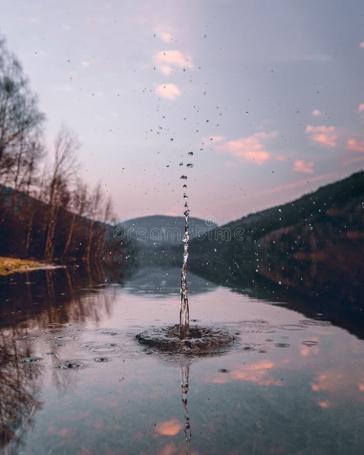 Vertical Shot of Falling Water Drop Splash on a Lake in Mountains ...