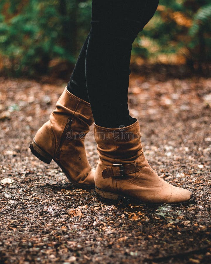 Vertical Shot of a Female in Brown Boots Walking in a Forest Stock ...