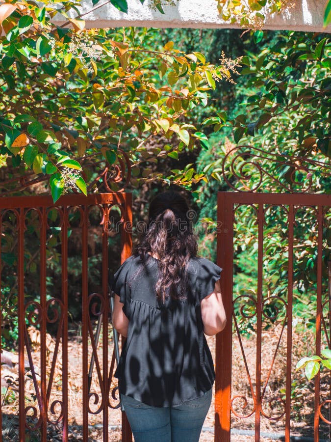 Vertical Shot of a Female Entering the Garden through a Gate Stock Photo - Image of outside ...