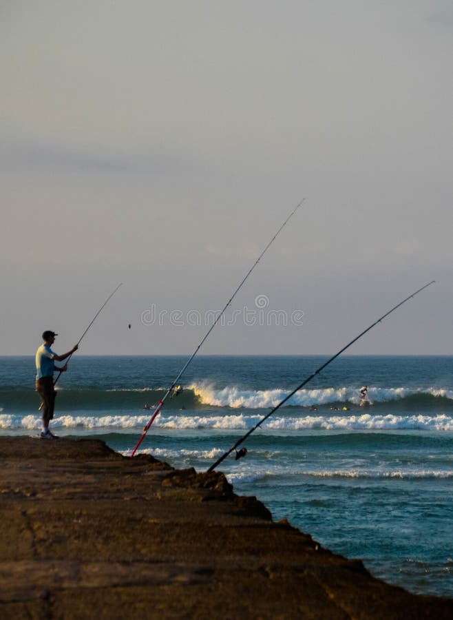 Vertical Shot of a Fisherman Catching Fish from the Sea Editorial Photo ...