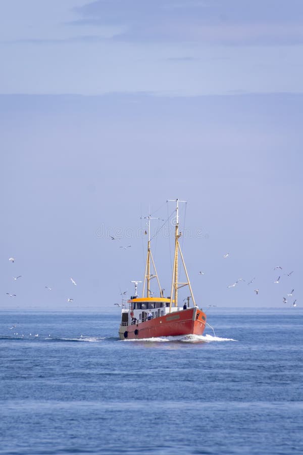 Vertical Shot of a Fishing Boat in the Sea Stock Photo - Image of ...