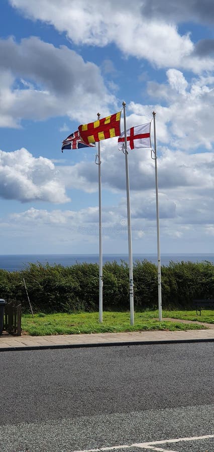 Vertical Shot of the Flags of Three Nations Stock Photo - Image of ...