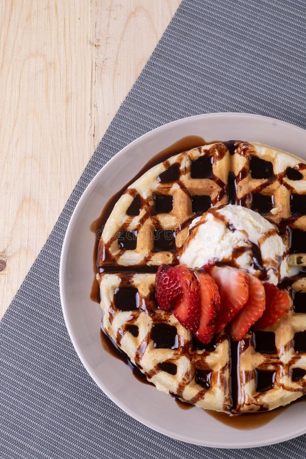 Vertical Shot of Fluffy Waffles a La Mode with Chocolate Syrup and ...