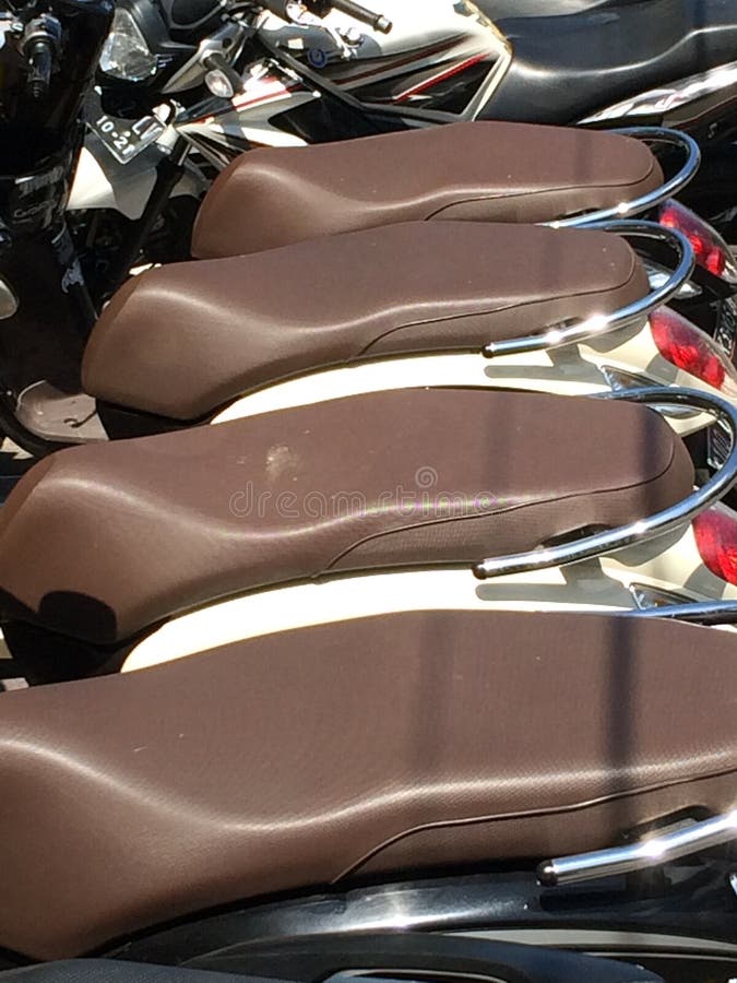 Vertical Shot of Four Brown-seated Mopeds Aligned Next To Each Other ...