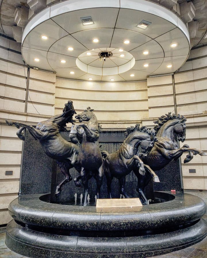 Vertical Shot of Four Horses Sculpture on a Black Granite Base Under a ...