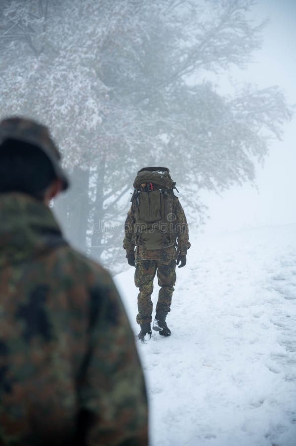 Vertical Shot of German Soldiers at a March during the Snowfall in a ...