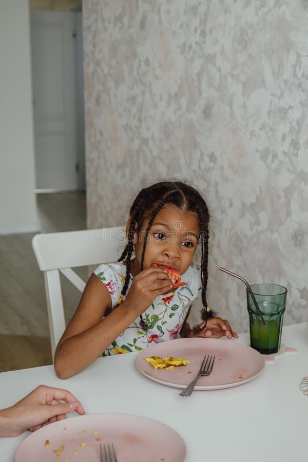 Vertical Shot of a Girl Eating in the Kitchen Stock Photo - Image of ...