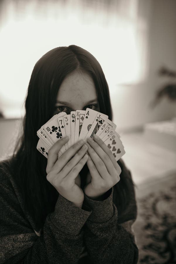 Vertical Shot of a Girl Hides Behind Playing Cards Stock Photo - Image ...