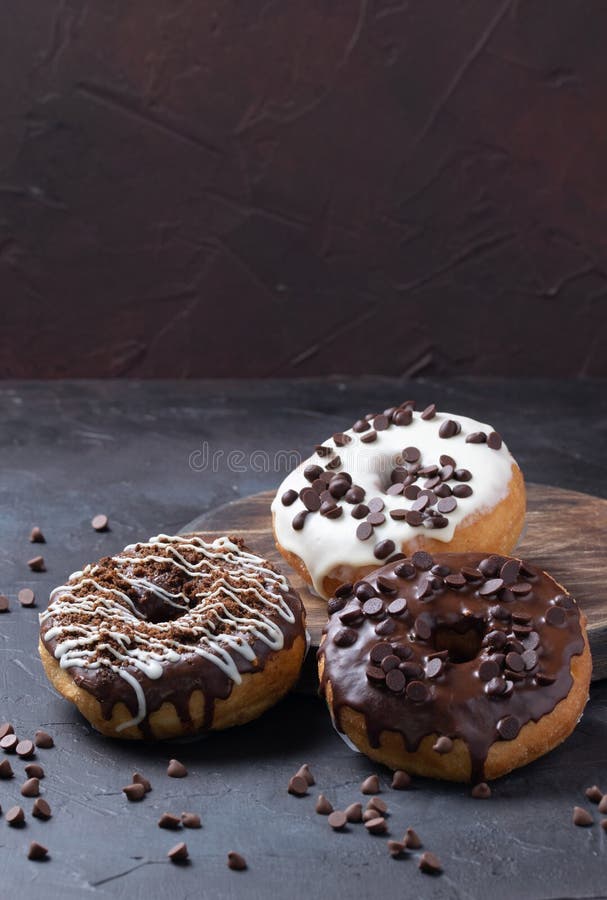Vertical Shot of Glazed Donuts Topped with Chocolate Chips on a Rustic ...