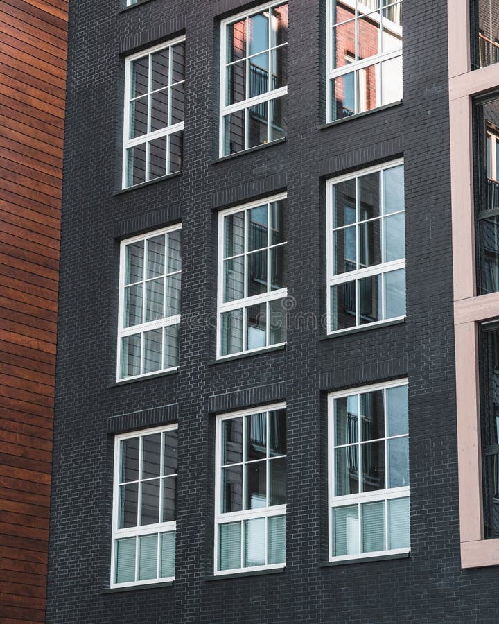 Vertical Shot of a Grey Building with a Lot of Windows - Great for a ...
