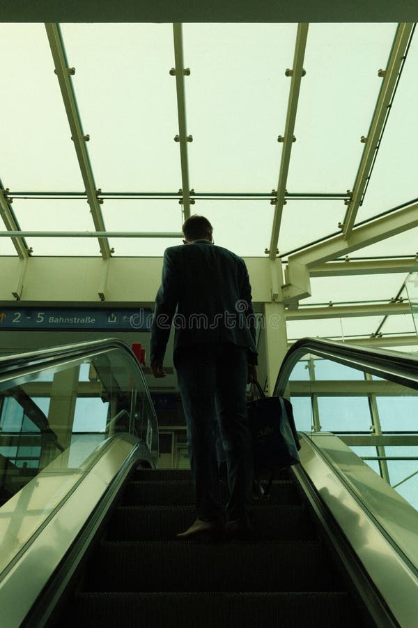 Vertical Shot of a Guy Going Up on an Escalator Inside a Building Stock ...