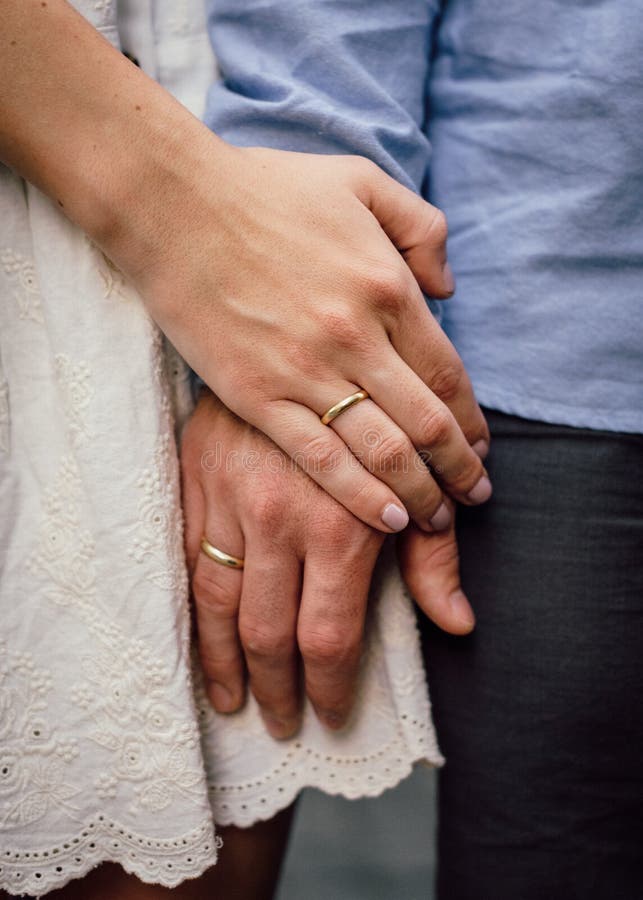 Vertical Shot of the Hands of a Married Couple with Rings Stock Photo ...