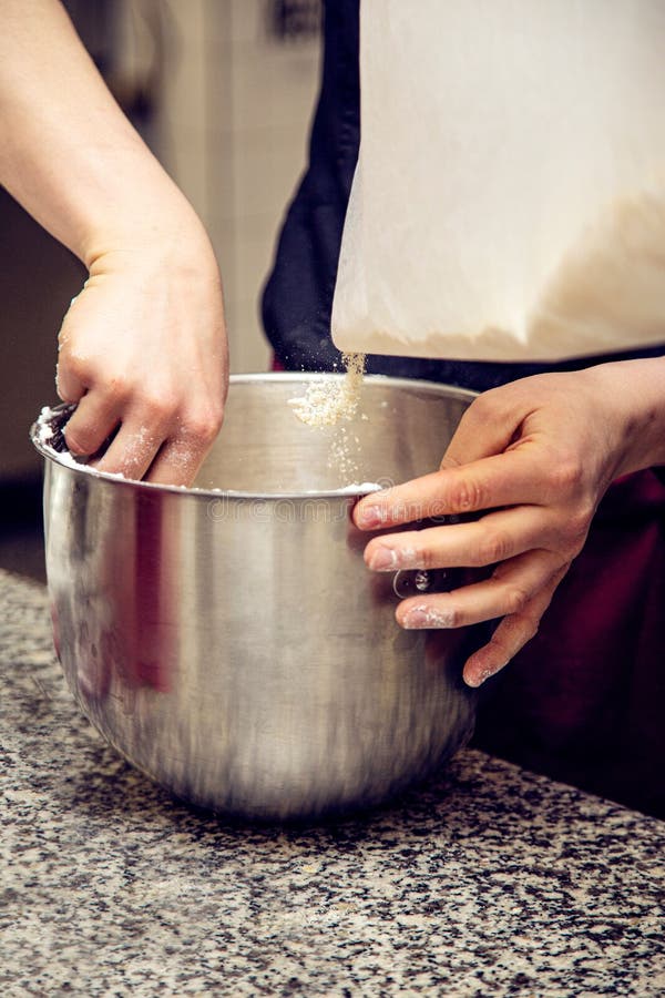 Vertical Shot of Hands Stirring the Dough in a Metal Bowl on the Table ...