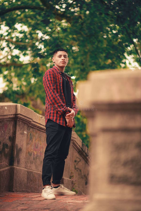 Vertical Shot of a Handsome Young Man Standing in a Playground Stock ...