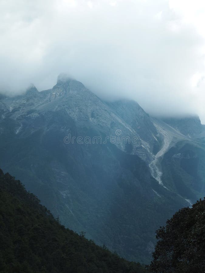 Vertical Shot of High Mountain Covered with Fog Stock Image - Image of ...