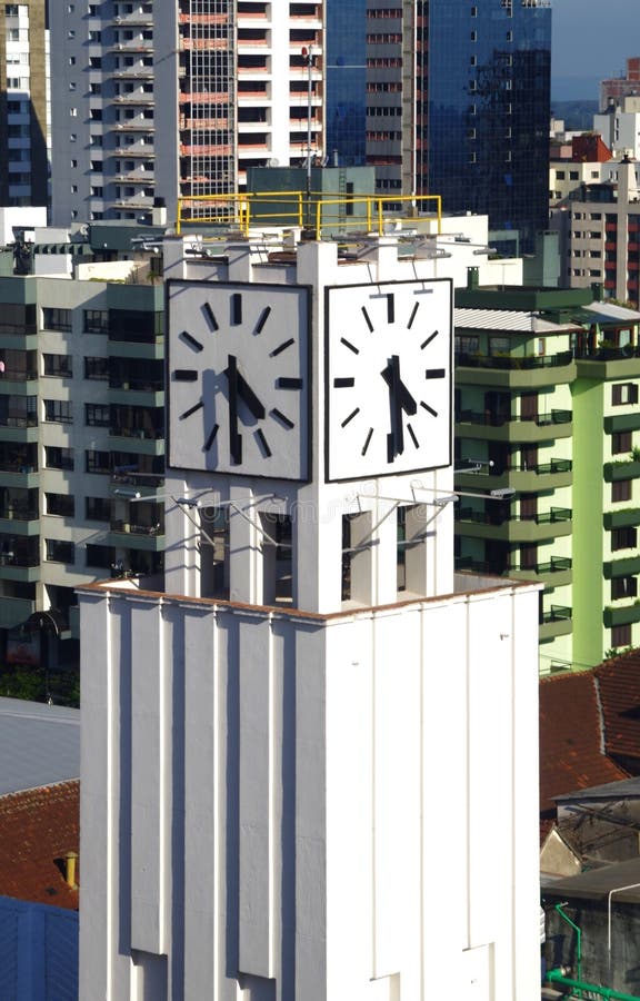 Vertical Shot of a High-rise White Tower with a Huge Analog Clock on it ...