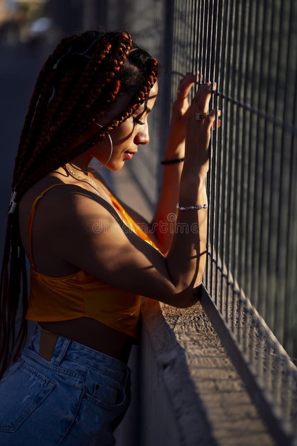 Vertical Shot of a Hispanic Woman with Braids Outdoors Stock Photo ...