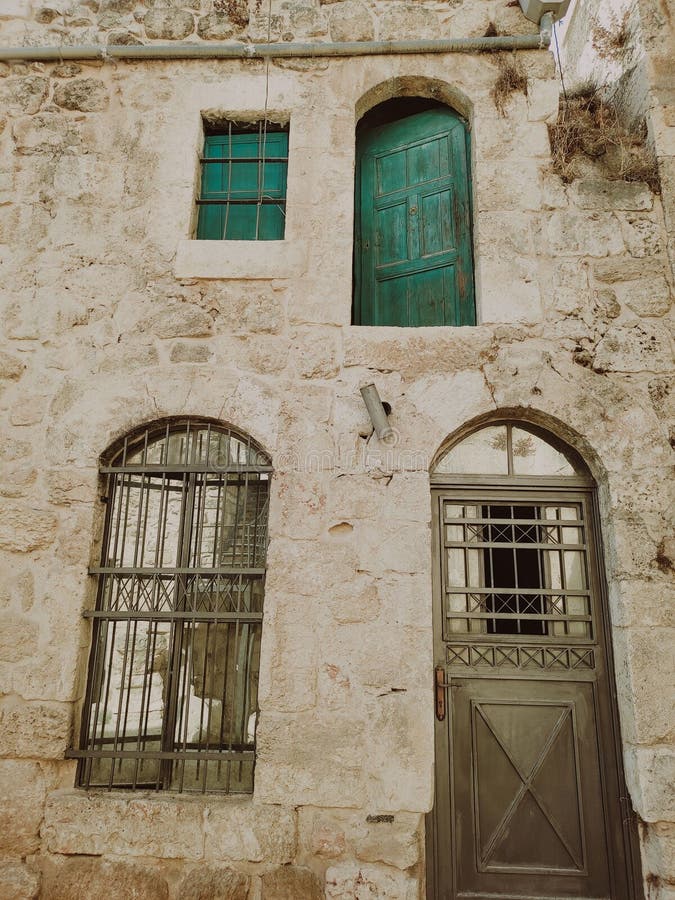 Vertical Shot of a Historic Stone Wall with Doors and Windows in ...