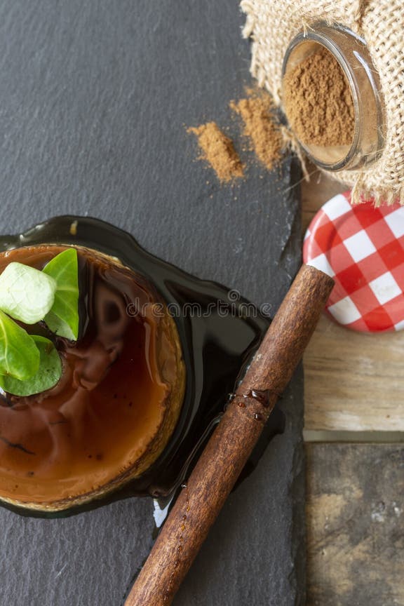 Vertical Shot of Homemade Custard Pudding with a Mint Leaf and Syrup ...