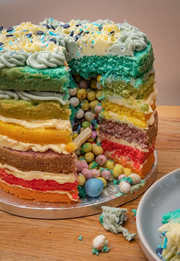 Vertical Shot of a Homemade Sliced Open Layered Rainbow Cake with Candy ...