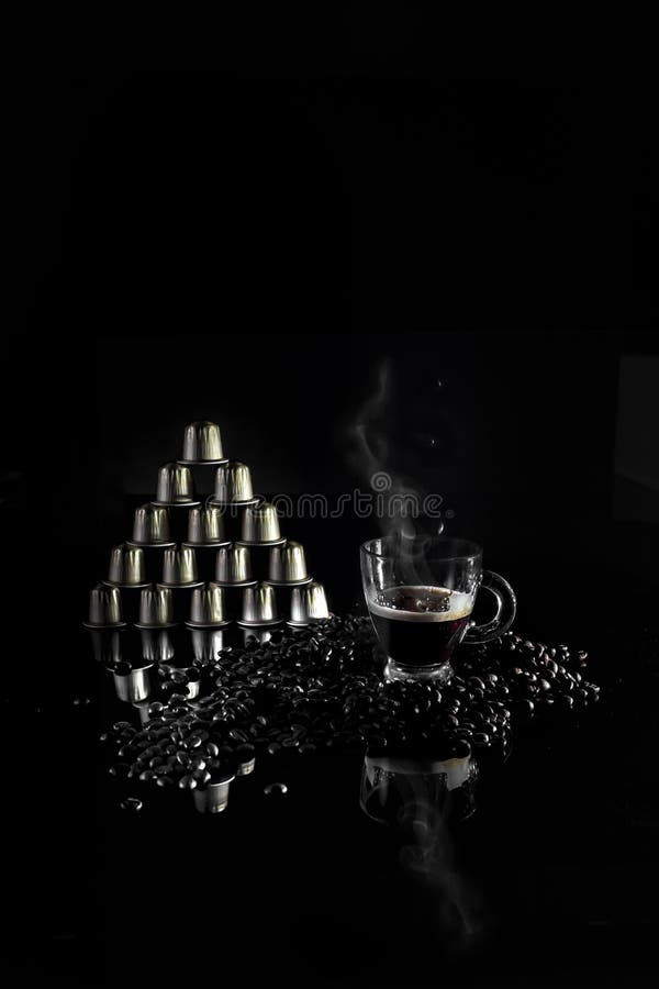Vertical Shot of a Hot Coffee with Coffee Capsule Pyramid and Beans ...