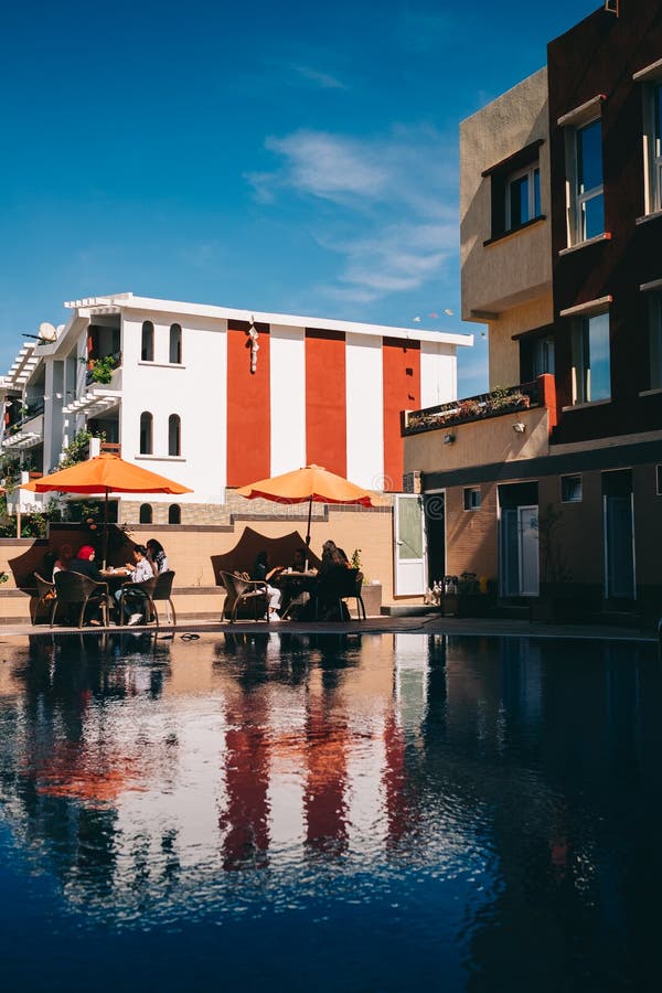 Vertical Shot of a Hotel Pool with People Having Lunch. Editorial ...