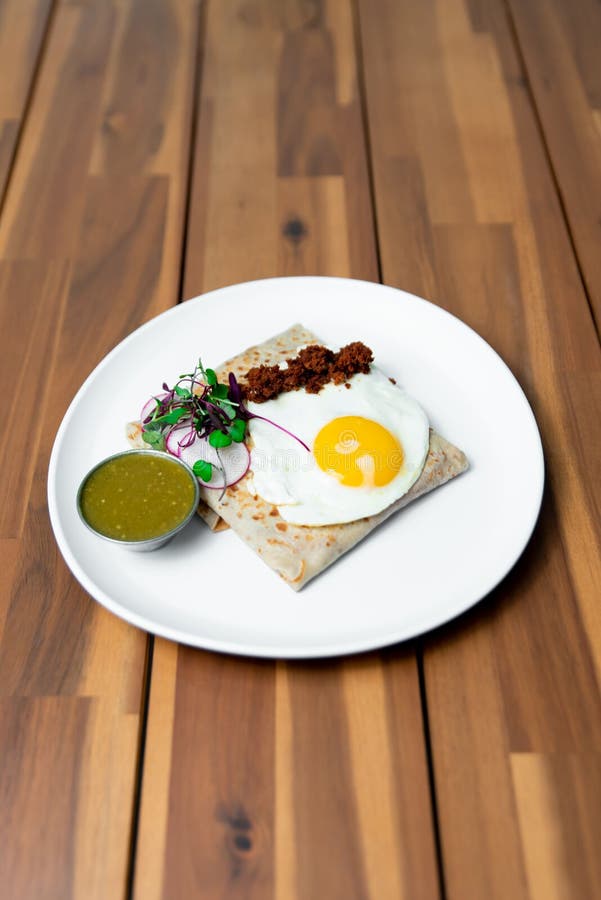 Vertical Shot of a Huevos Ranchero Dish with a Fried Egg and a Mexican ...