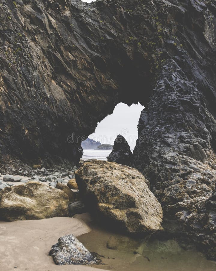 Vertical Shot of a Huge Rock with a Hole Stock Photo - Image of scenic ...