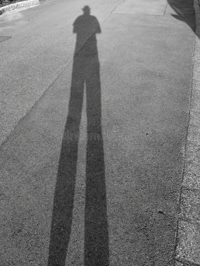 Vertical Shot of Human Shadow on a Gray Concrete Surface Stock Image ...