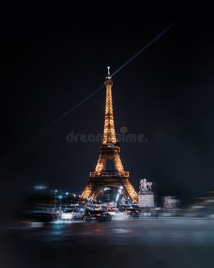 Vertical Shot of Illuminated Eiffel Tower at Night with Blur ... Vertical Shot of Illuminated Eiffel Tower at Night with Blur ...