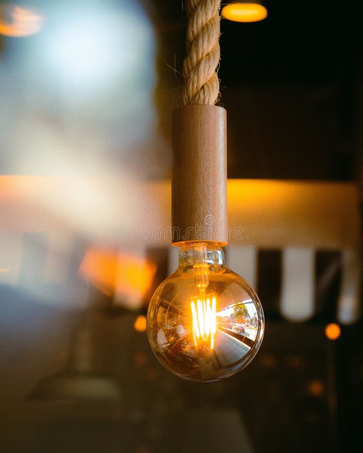 Vertical Shot of an Illuminated Lightbulb in a Blur Stock Photo - Image ...