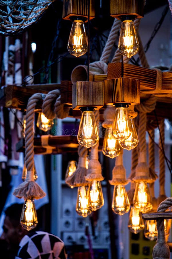 Vertical Shot of Illuminated Lightbulbs Hanging Outdoors Stock Photo ...
