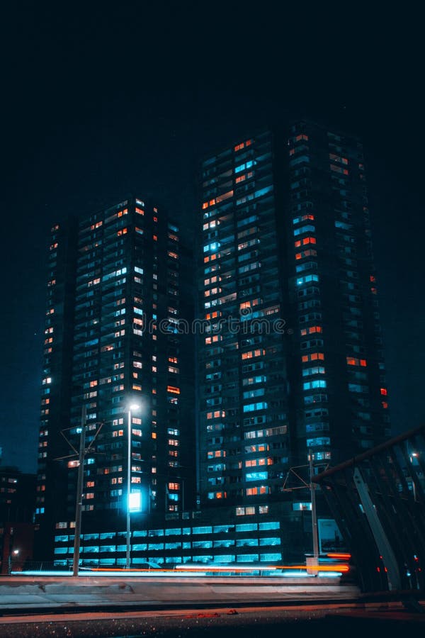 Vertical Shot of Illuminated Modern Office Building at Night with Glass ...