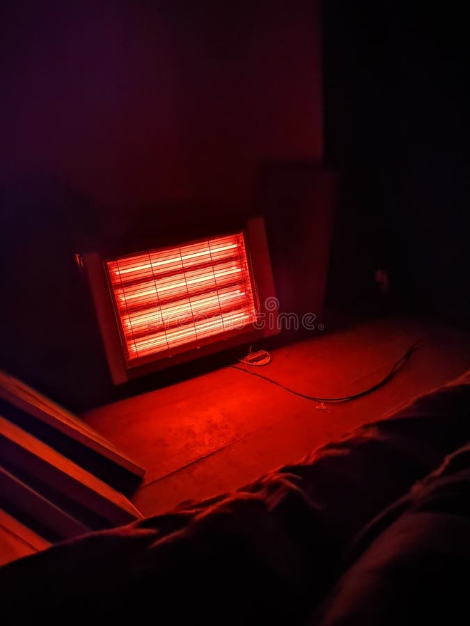 Vertical Shot of an Illuminating Electric Heater in a Dark Room Stock ...