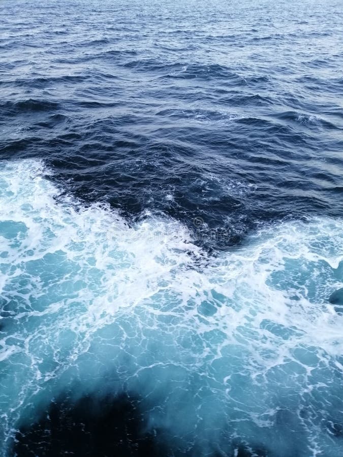 Vertical Shot of Indigo-colored Ocean Water with Foams Stock Photo ...