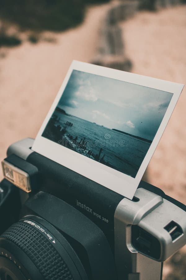 Vertical Shot of an Instax Polaroid Camera Ejecting a Picture of the ...