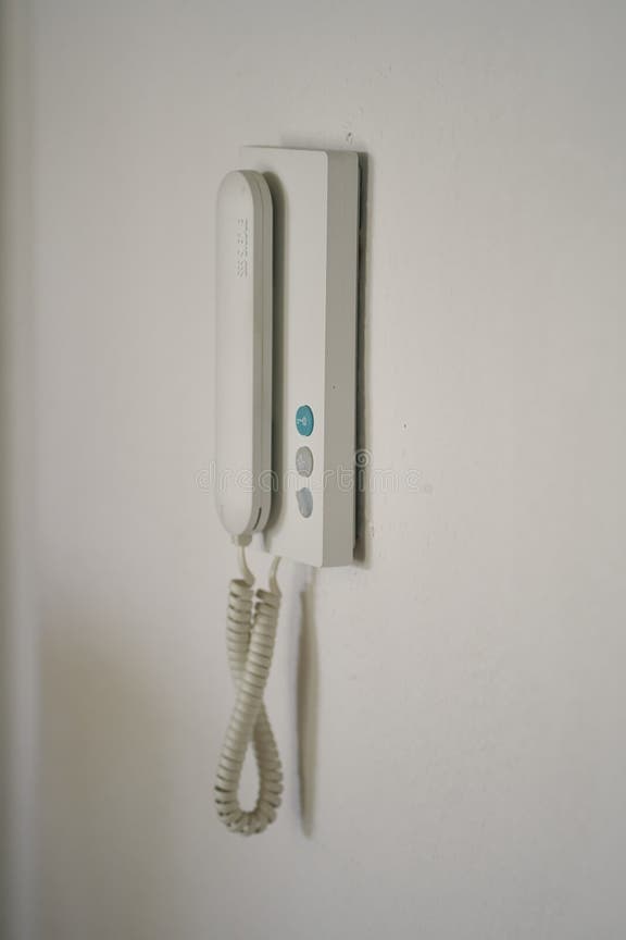 Vertical Shot of an Intercom Receiver on a White Wall in the Apartment ...