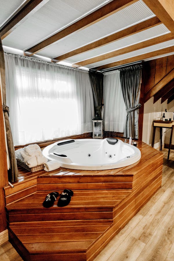Vertical Bathtub with Marble Surround Inside a Bathroom Against the ...