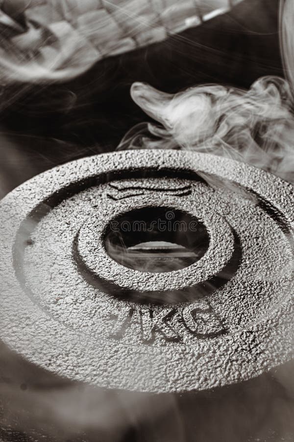 Vertical Shot of a 1 Kg Metal Plate with Smoke in the Foreground Stock ...