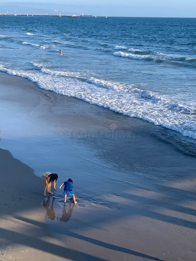 Vertical Shot of Kids Playing at the Beach Stock Image - Image of sand ...