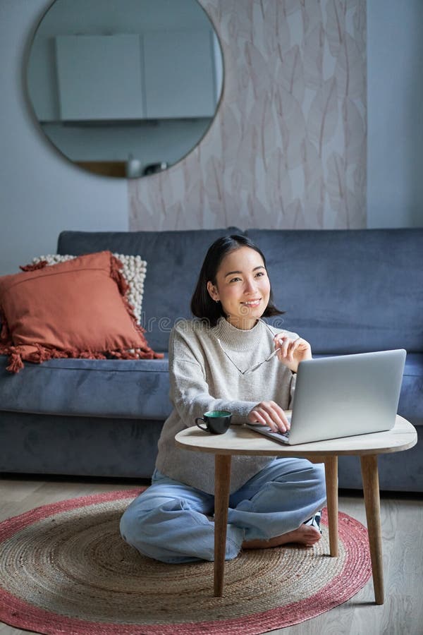 Vertical Shot of Korean Working Woman, Sitting on Floor at Home with ...