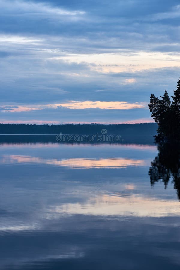 Vertical Shot of a Lake with a Reflection of a Forest Stock Image ...