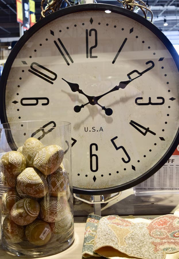 Vertical Shot of a Large Clock Face and a Glass Jar with Decorative ...