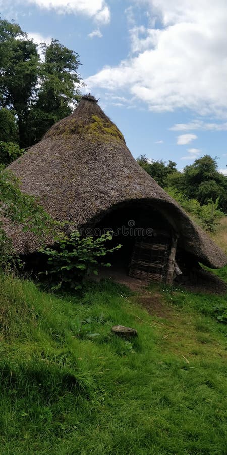 Vertical Shot of the Late Iron Age Roundhouse in the Grass Surrounded ...