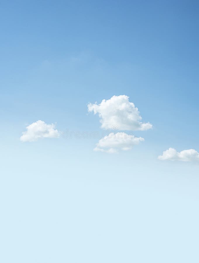 A Vertical Shot of a Light Blue Sky with Small Clouds Floating Stock ...