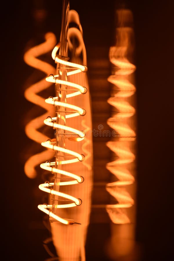 Vertical Shot of a Light Bulb Creating a Zigzag Reflection Stock Photo ...